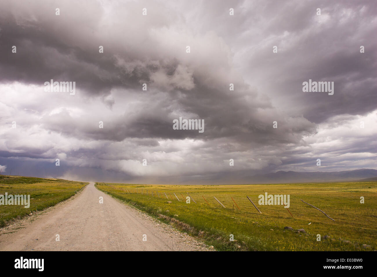 MONIDA, MONTANA, USA - Dark brooding storm clouds over dirt road and ...