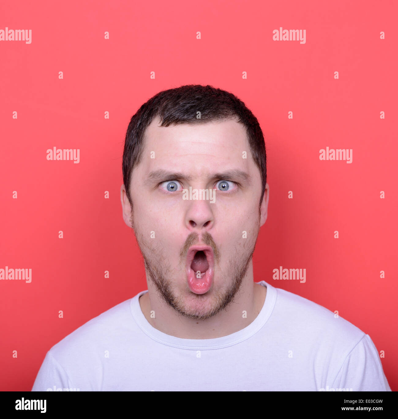 Portrait of girl with funny face against red background Stock Photo - Alamy