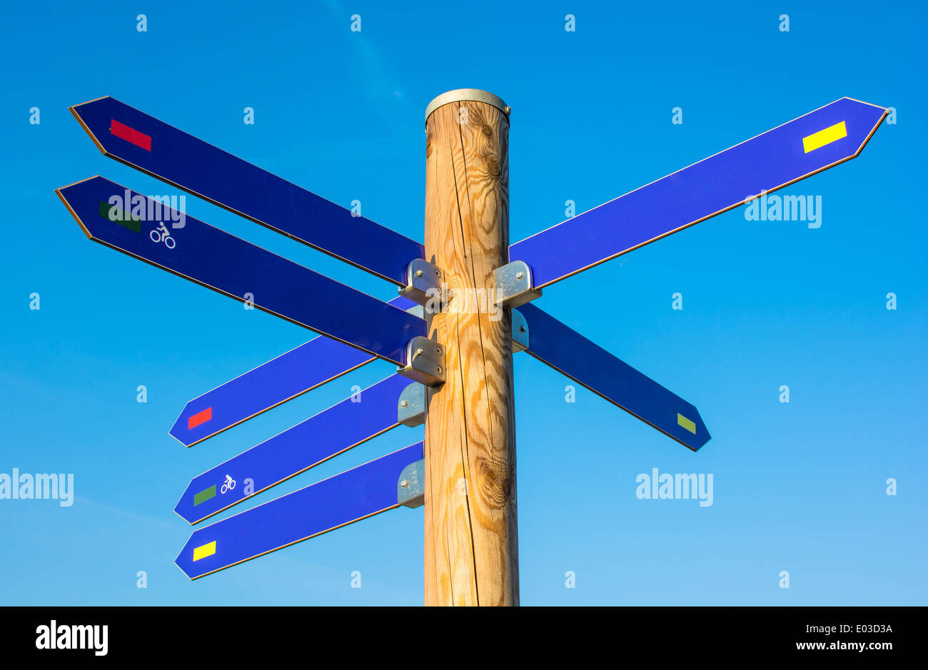 Wooden Pole With Numerous Direction Arrows Stock Photo - Alamy