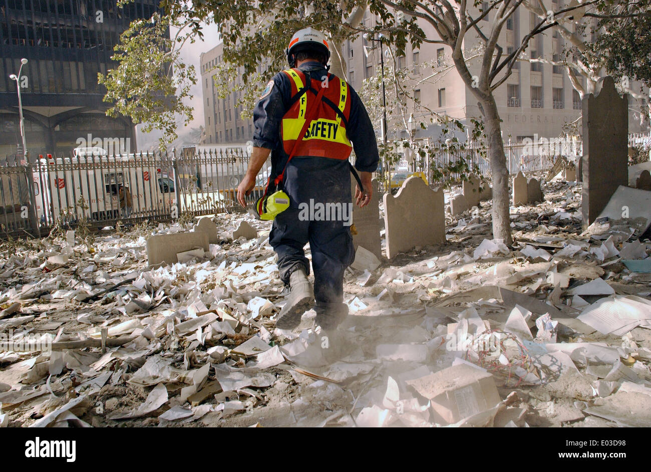 A fire fighter assists in recovery of victims amongst the wreckage of ...