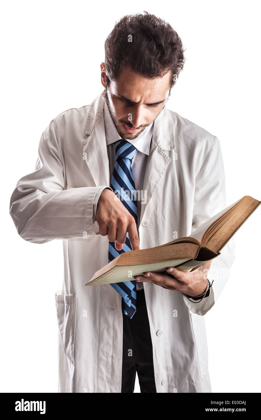 a young and handsome doctor or medical student reading an ancient book ...