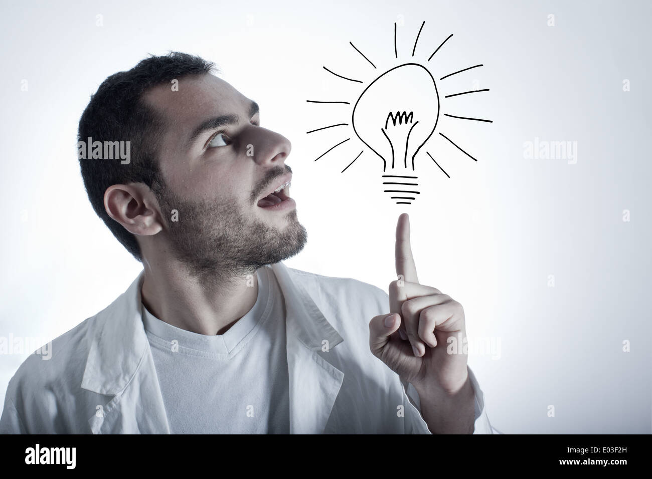 A young researcher/doctor in a lab coat having an idea (light bulb draw ...