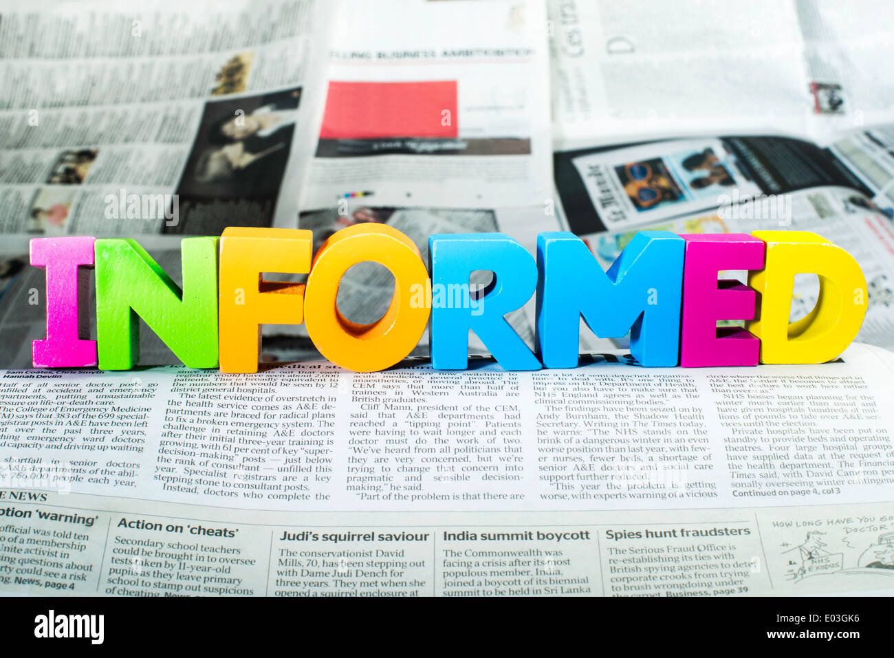 Word informed on newspaper. Wooden letters Stock Photo - Alamy