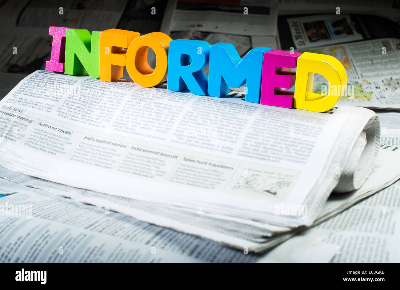 Word informed on newspaper. Wooden letters Stock Photo - Alamy