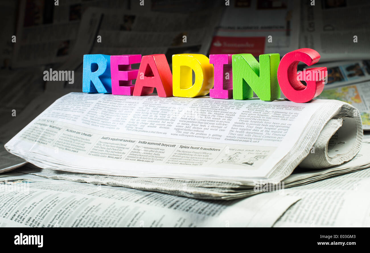 Word reading on newspaper. Wooden letters Stock Photo - Alamy