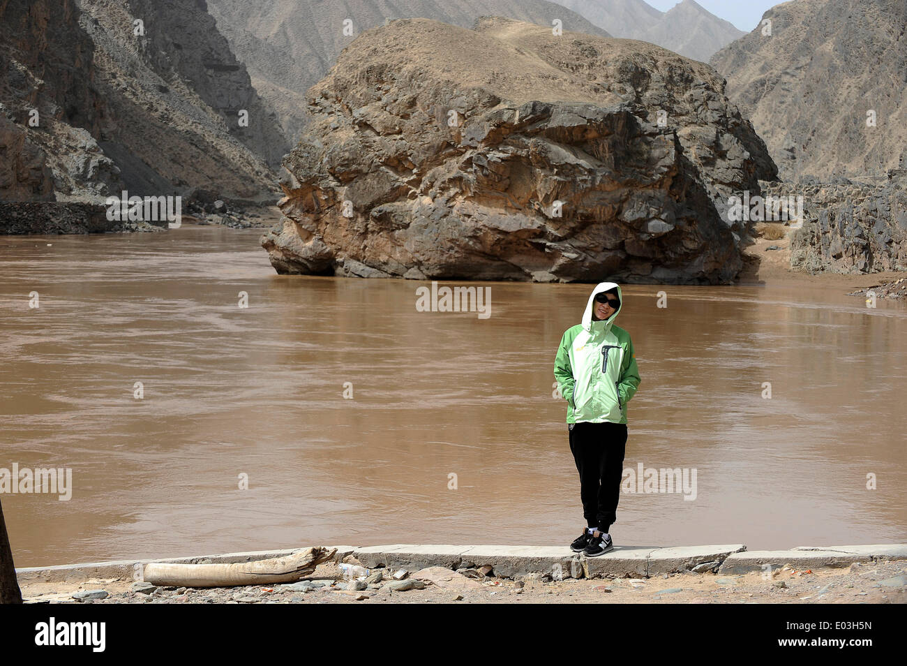 Yinchuan. 1st May, 2014. A tourist poses for photos beside the Yellow ...