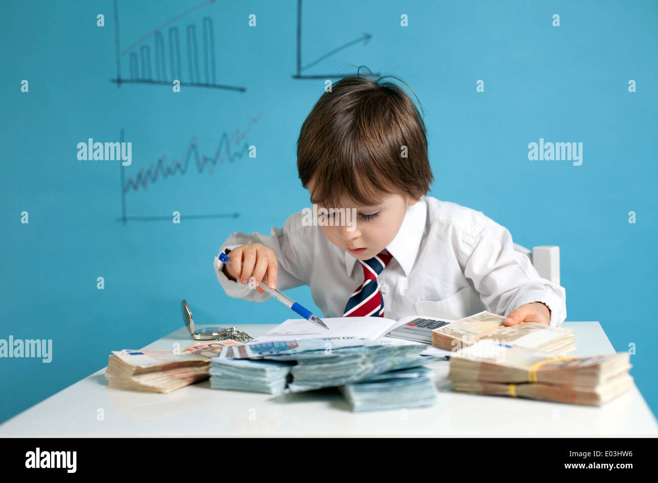 Young boy, counting money and taking notes Stock Photo - Alamy