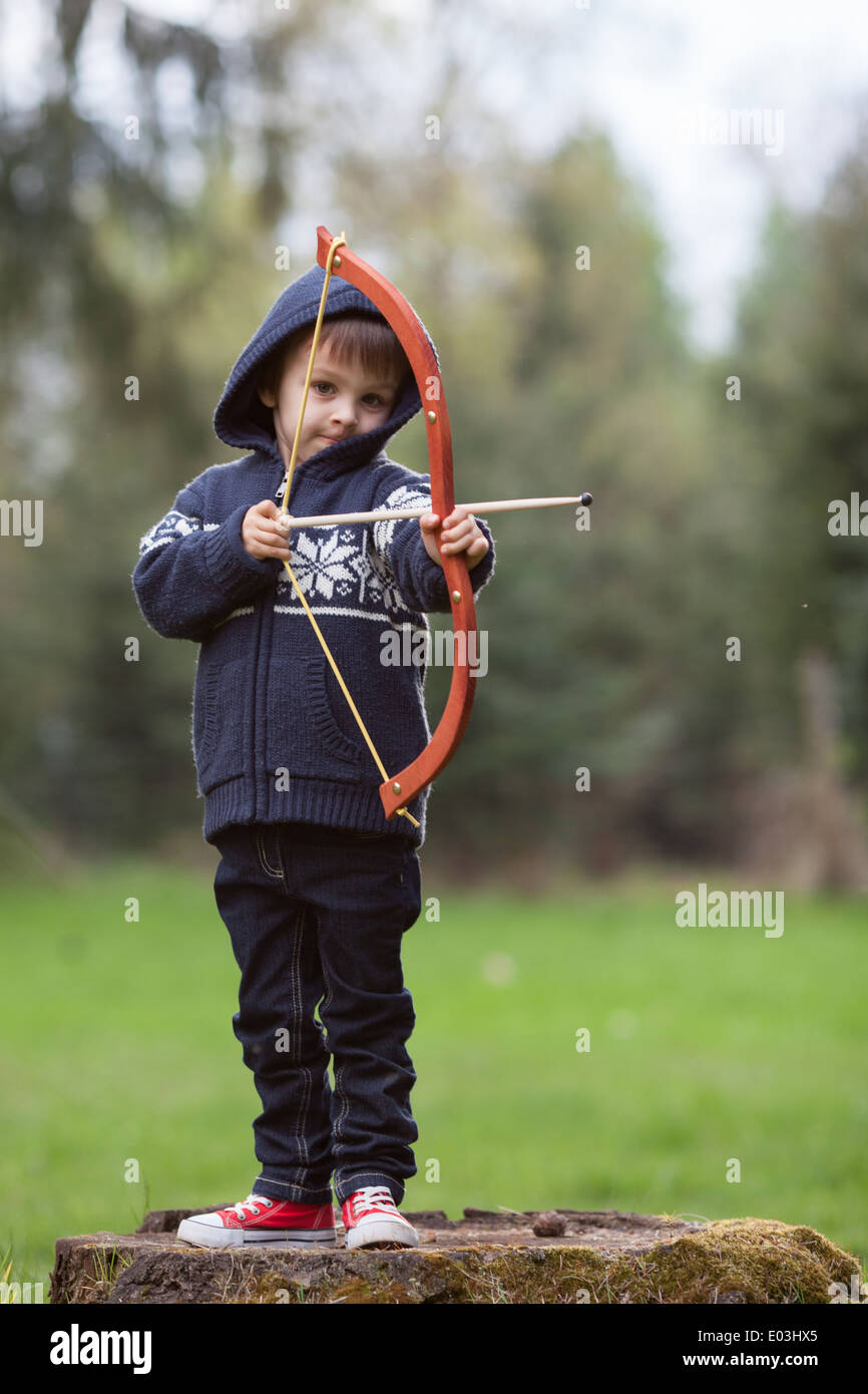 Boy shoots with bow at a target, in the open air Stock Photo - Alamy