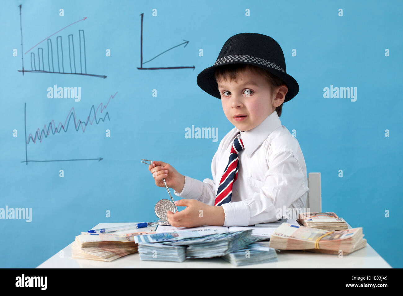 Young boy, counting money and taking notes Stock Photo - Alamy
