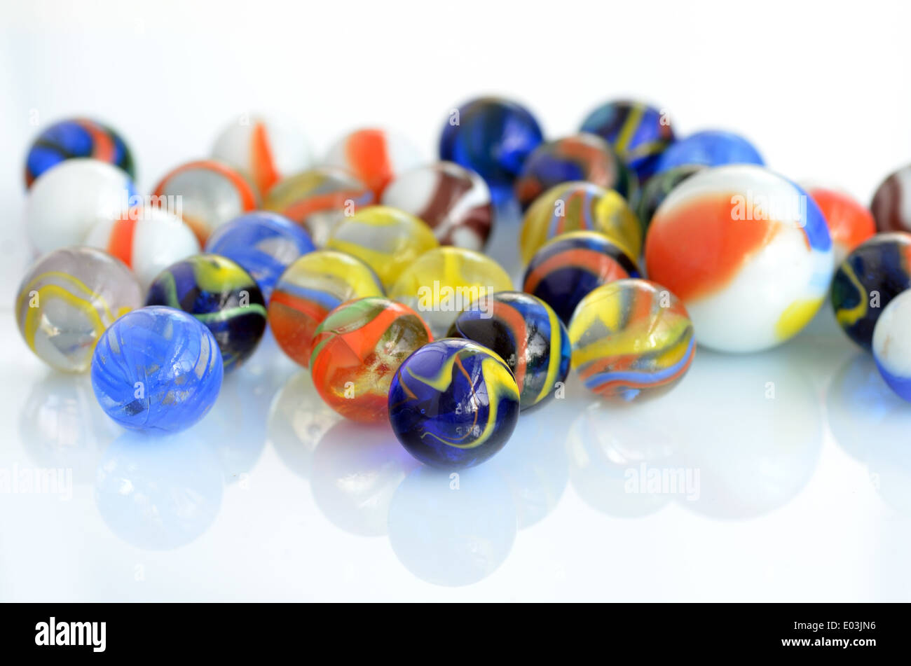 A handful of colorful glass marbles on a white background Stock Photo ...