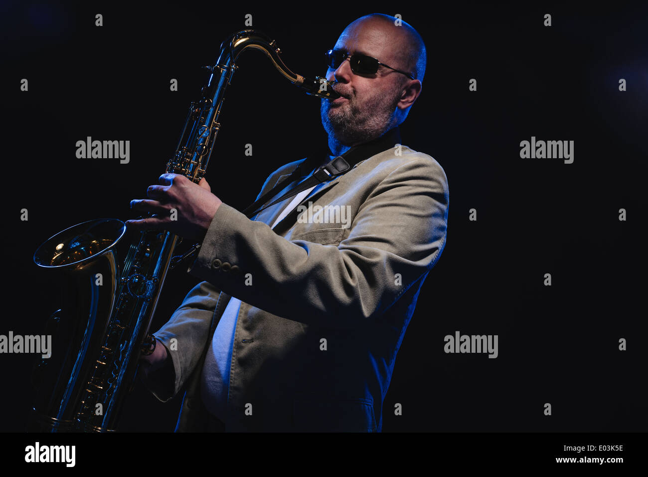 Adult musician playing tenor saxophone, blue smoky background Stock ...