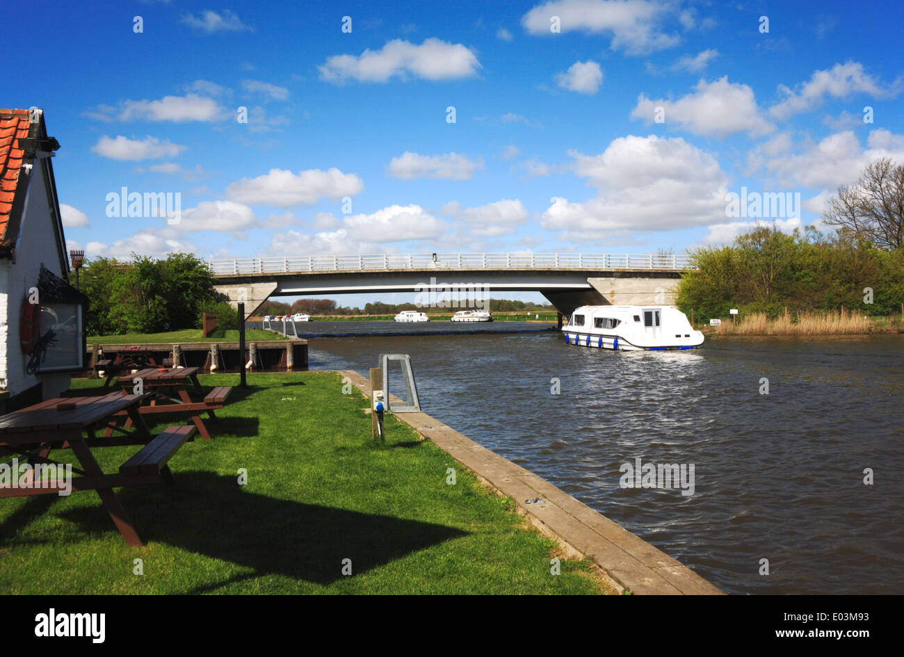 A cruiser on the Norfolk Broads about to pass under Acle bridge ...