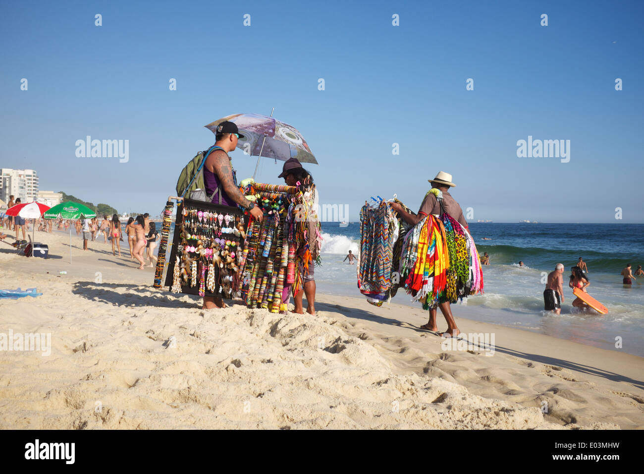 RIO DE JANEIRO, BRAZIL - JANUARY 22, 2014: Beach vendors stand with ...