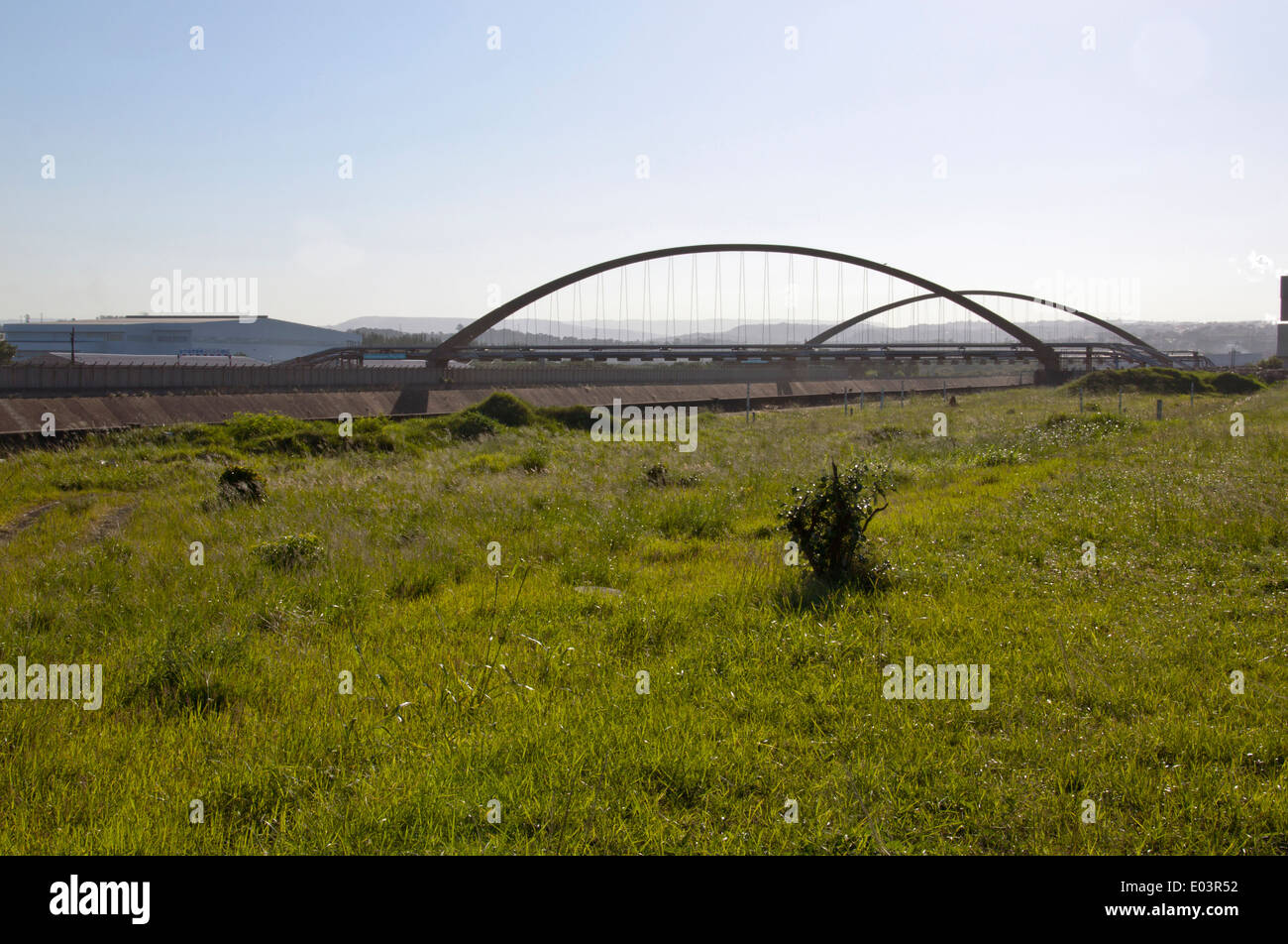 Two bridge arches stretching over man made canal in Durban South Africa ...