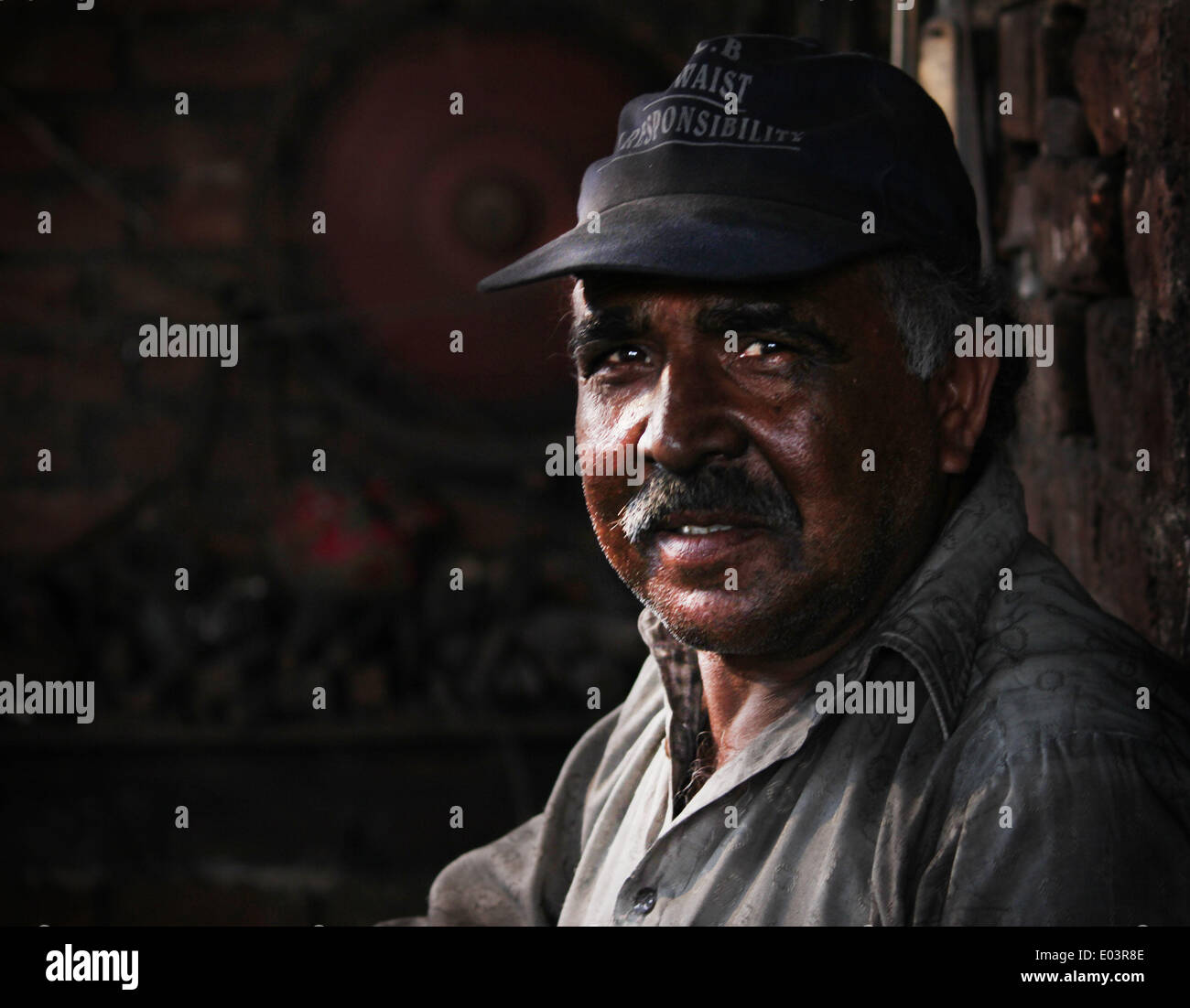 LAHORE, PAKISTAN, MAY 01: Pakistani blacksmiths work at an iron molding ...