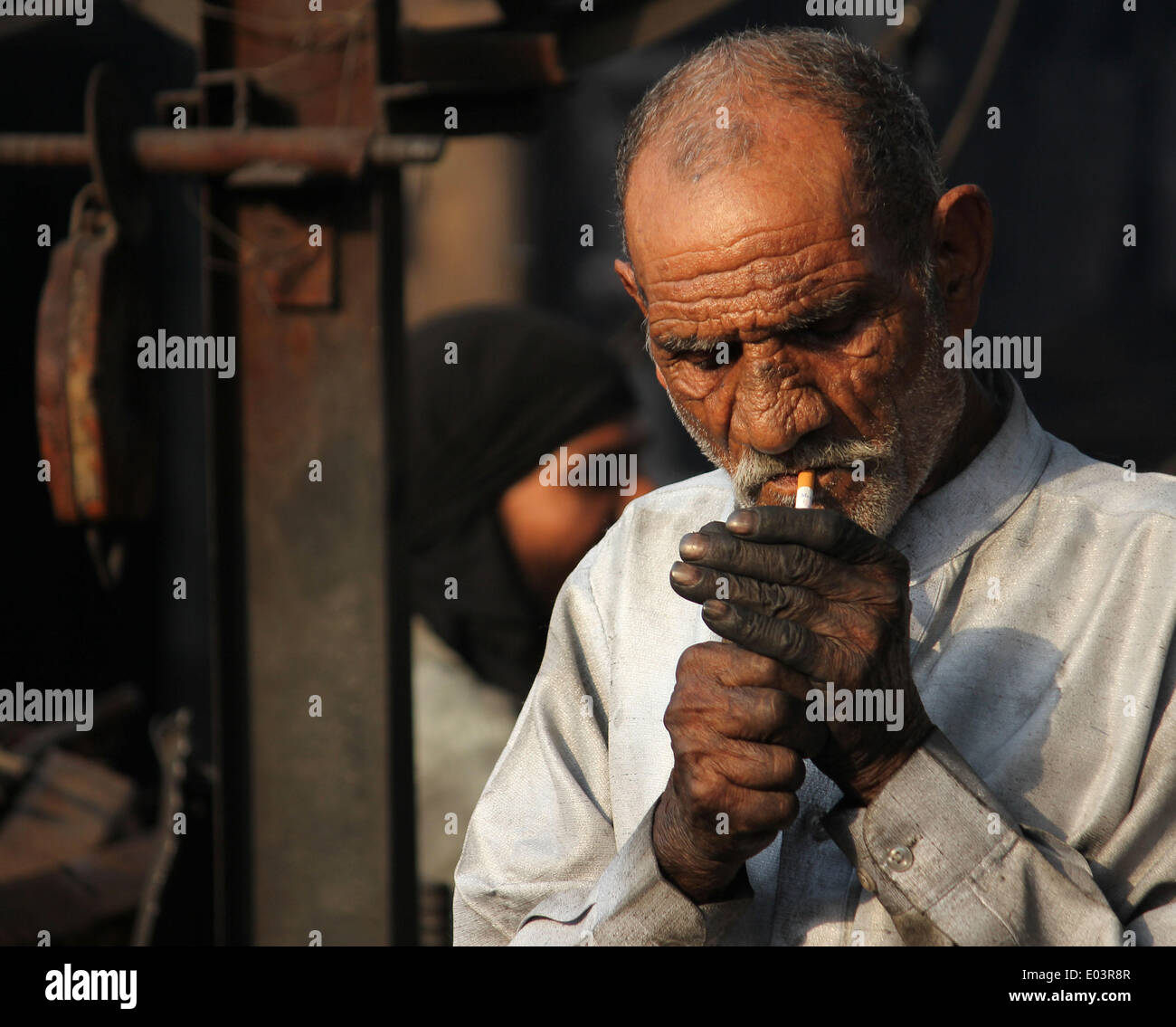 LAHORE, PAKISTAN, MAY 01: Pakistani blacksmiths work at an iron molding ...