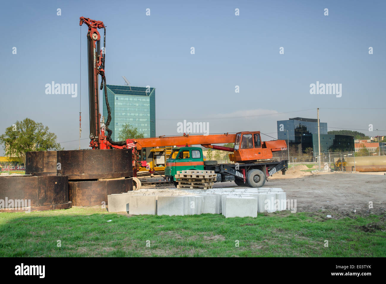 construction site with heavy machinery equipmen and crane cement blocks ...