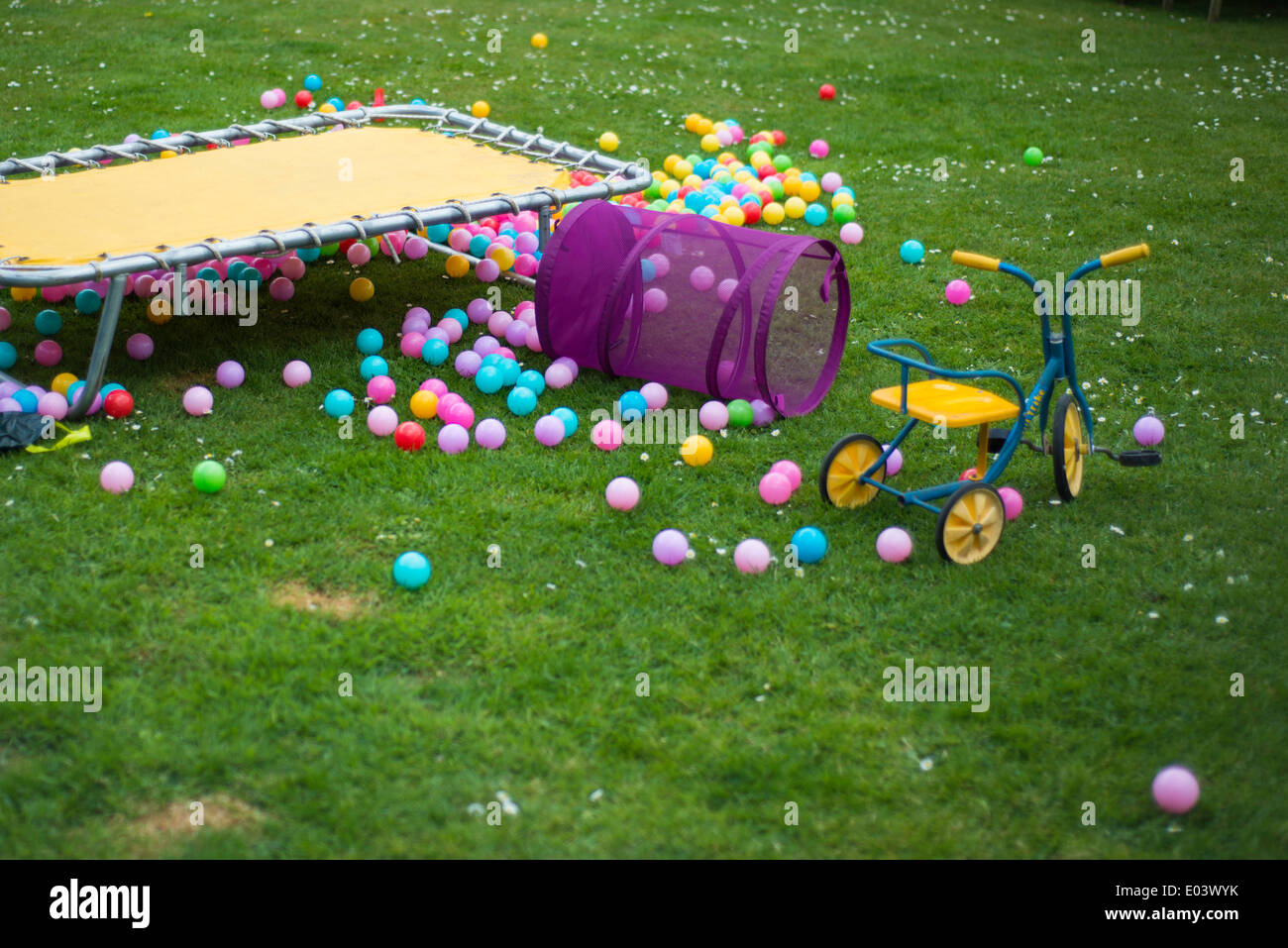 Messy Garden after Children. Balls, Trampoline and Trike Stock Photo ...