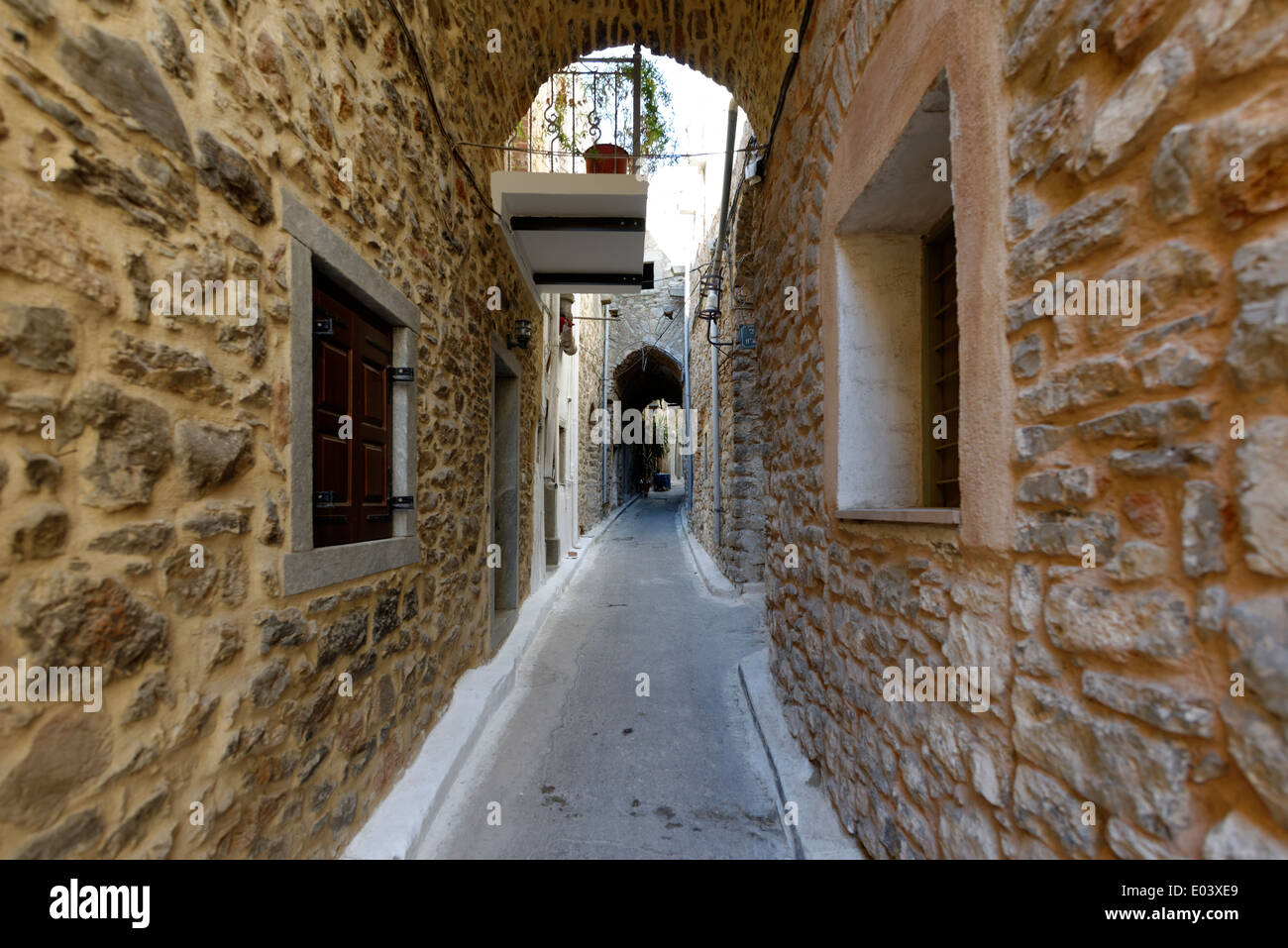 Narrow lane with vaulted arched passageway in medieval town Olympi ...