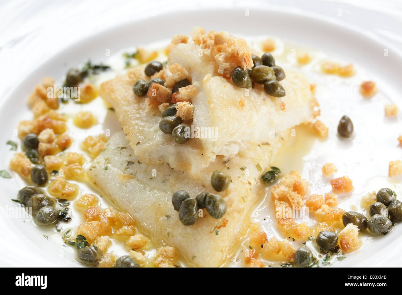 roasted peaces of fish with garnish on white background Stock Photo - Alamy