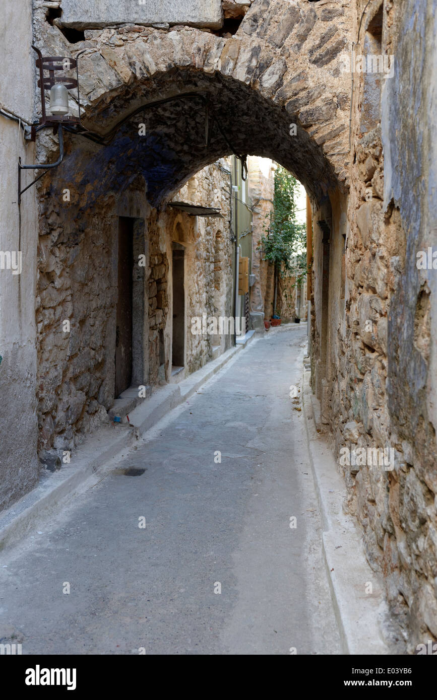 Narrow lane with vaulted arched passageway in medieval town Olympi ...