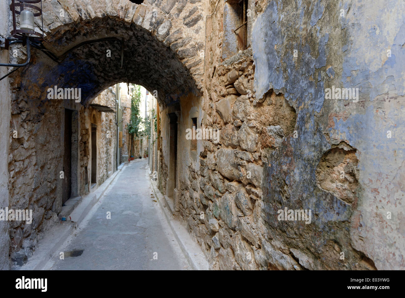 Narrow lane with vaulted arched passageway in medieval town Olympi ...