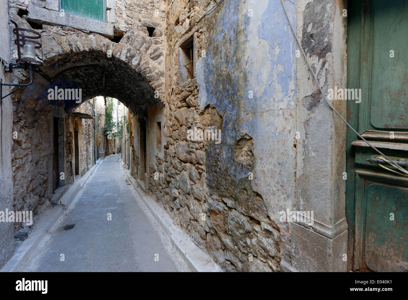 Narrow lane with vaulted arched passageway in medieval town Olympi ...