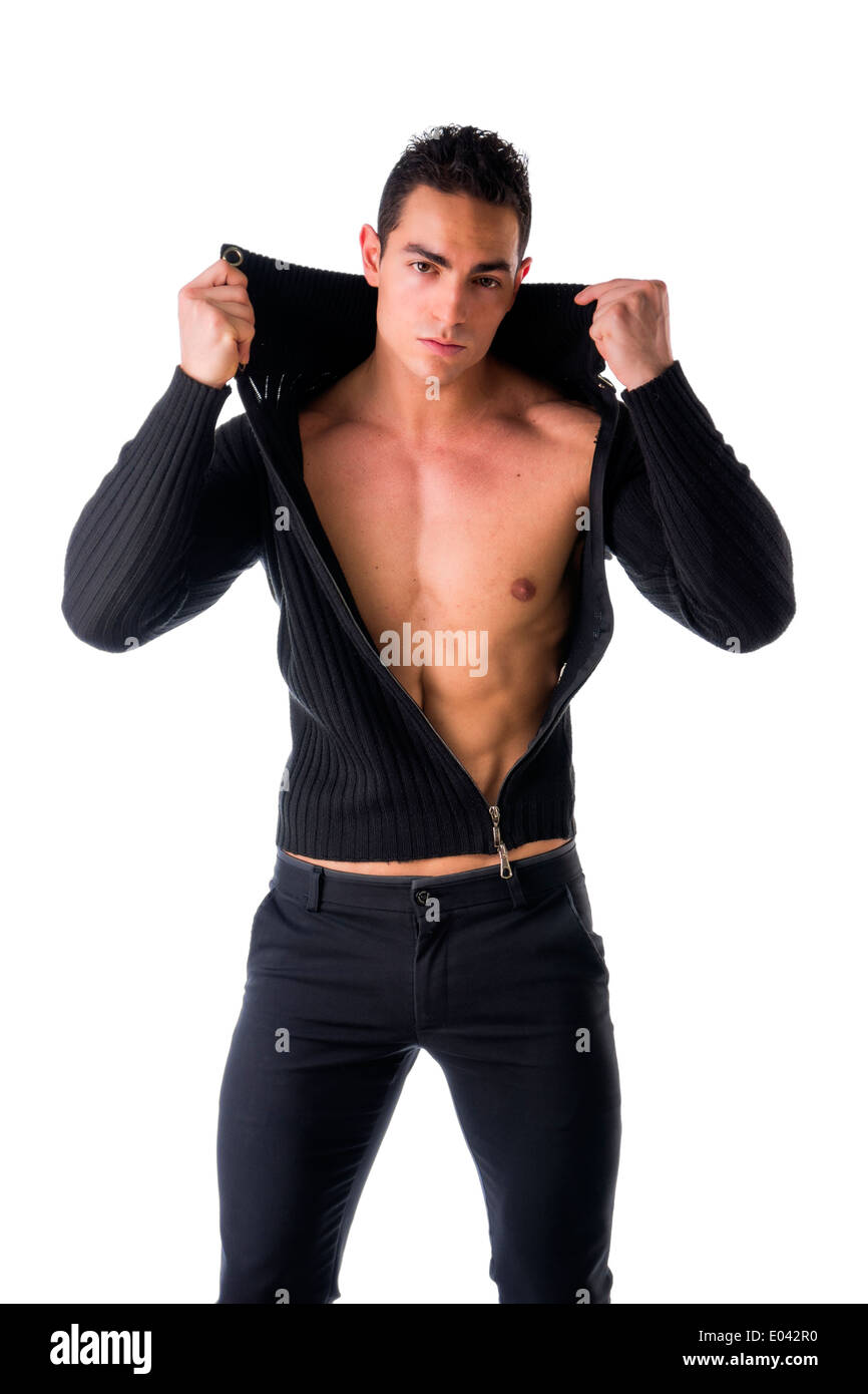 Confident, attractive young man with open sweater on muscular torso ...