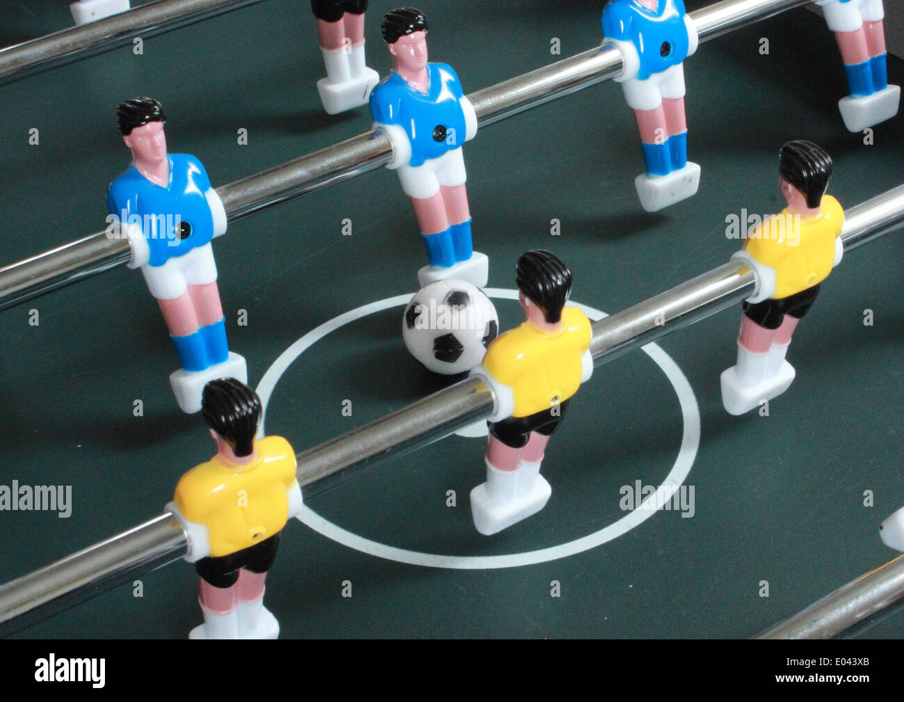 Football table game with blue and yellow players Stock Photo - Alamy