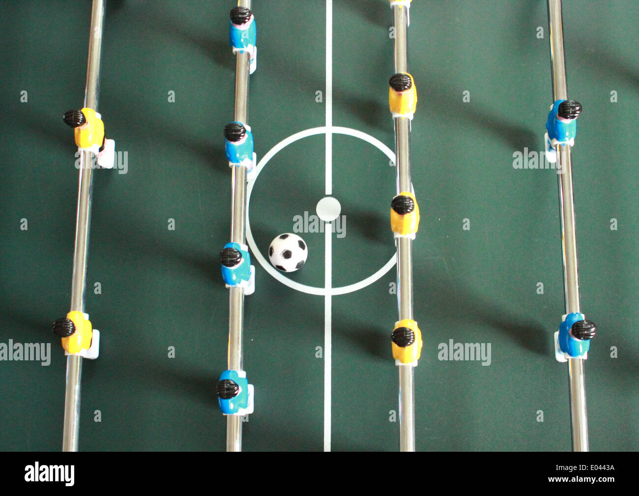 Football table game with blue and yellow players Stock Photo - Alamy