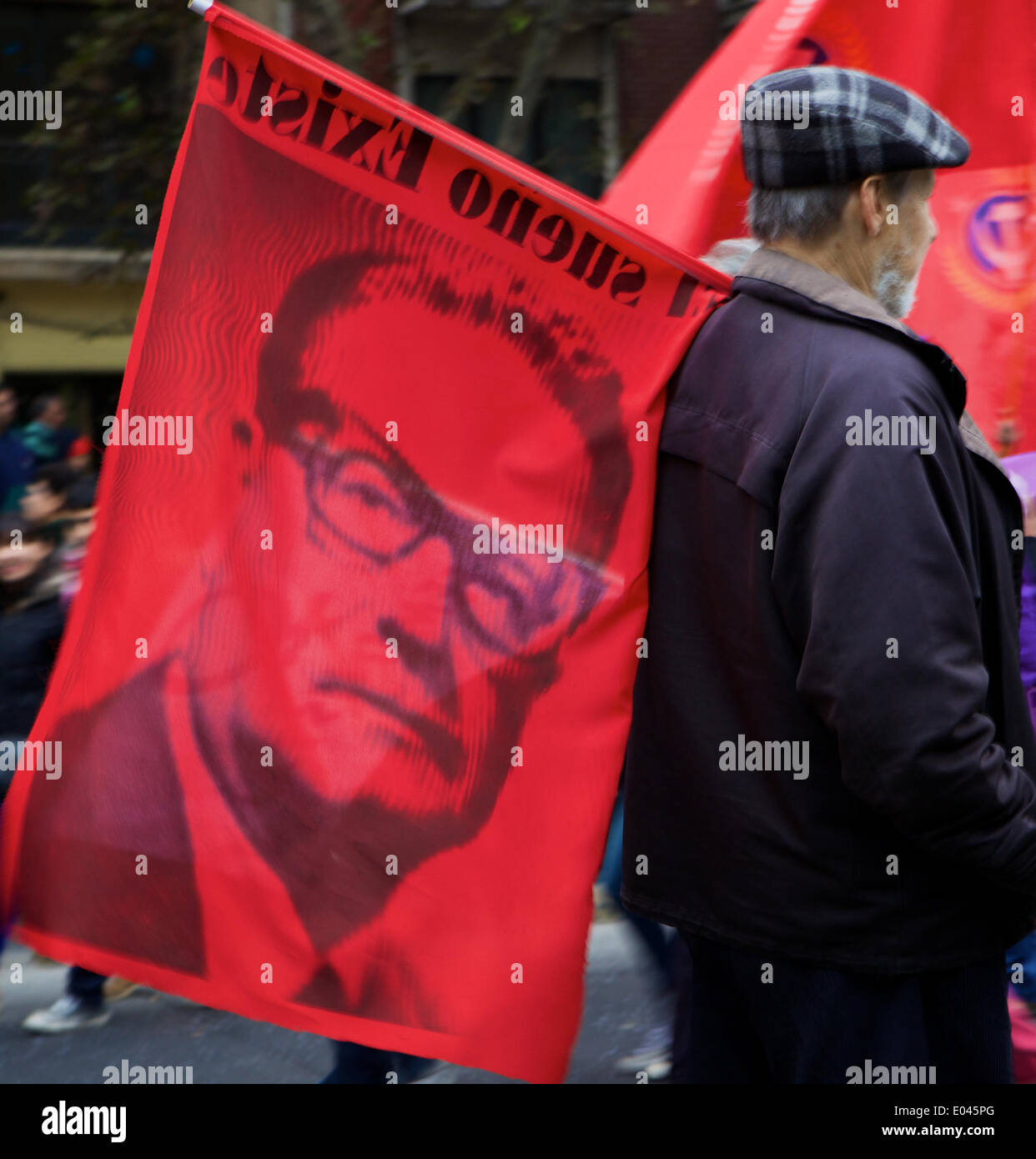Old man marching with a Photo of Salvador Allende during march of May ...