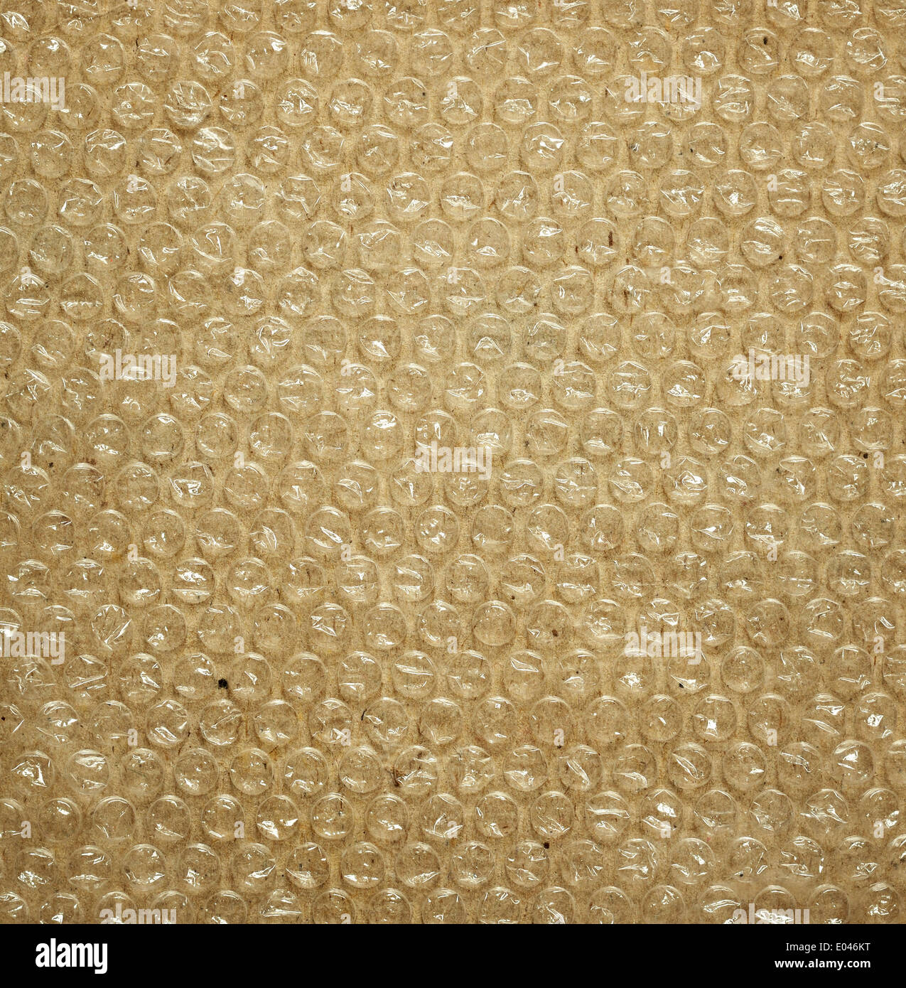 Plastic bubble packaging material on brown background Stock Photo - Alamy