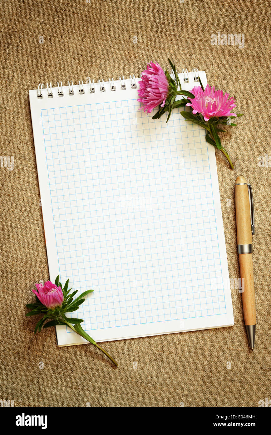 Aster flower buds and a notepad on canvas background Stock Photo - Alamy