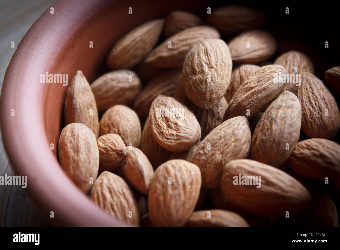 Almonds in bowl Stock Photo - Alamy