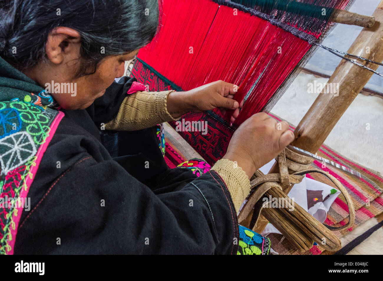 Indigenous female weaver weaving on a traditional loom in Sucre ...