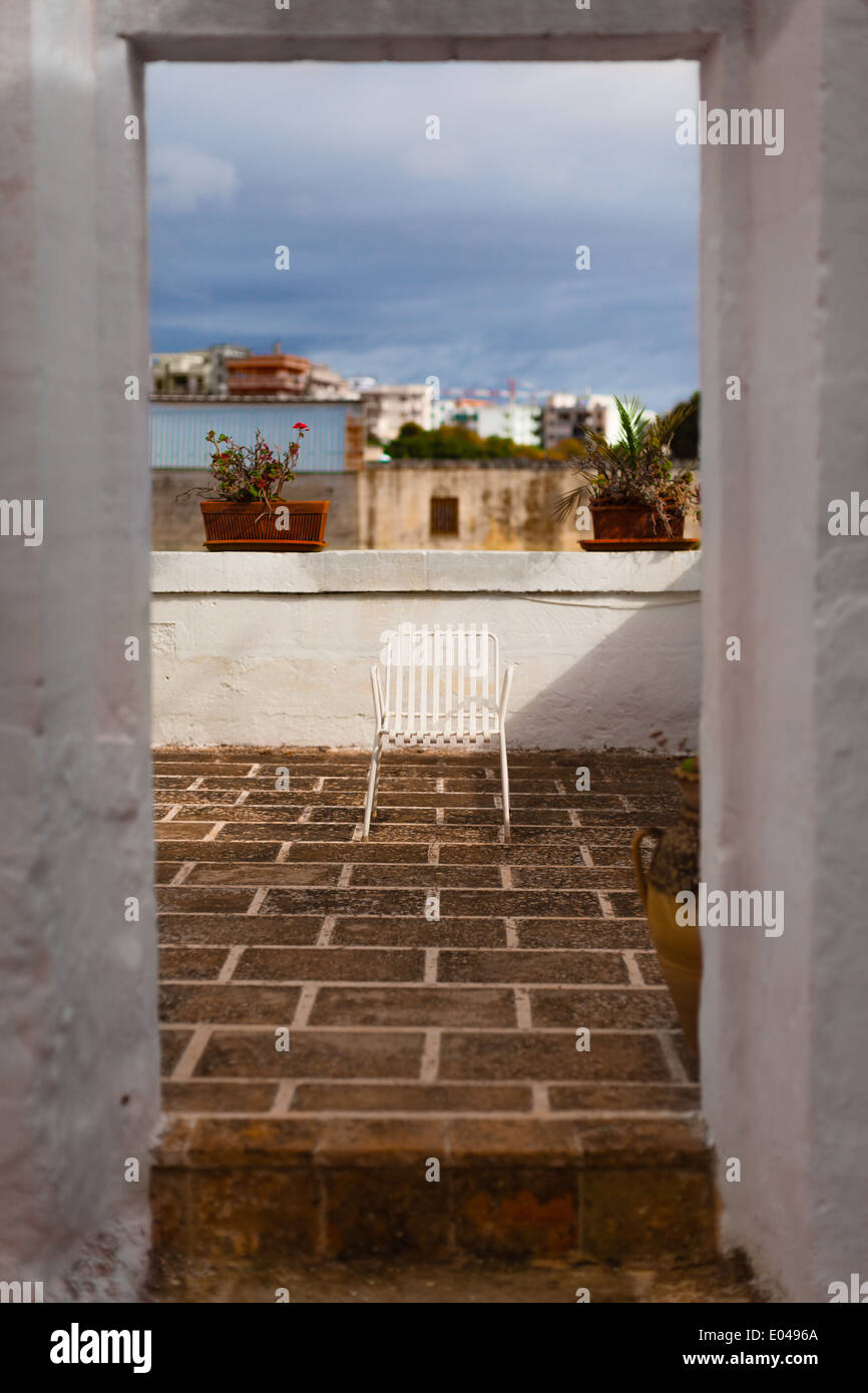 an old white chair at dusk in a mediterranean terrace Stock Photo - Alamy