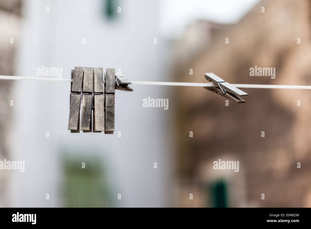 some old and weathered clothes pegs hanged on a whire Stock Photo - Alamy