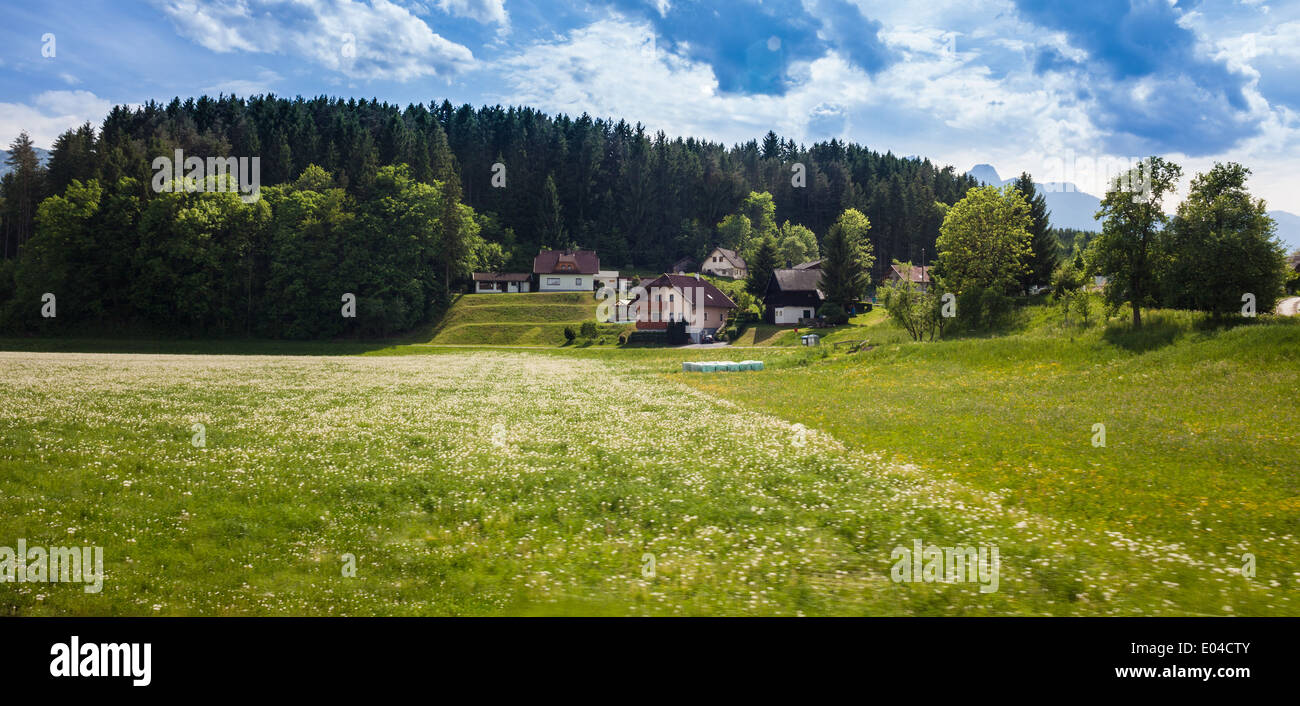 A rural scenic of southern Austria, with a typical house and mountains ...