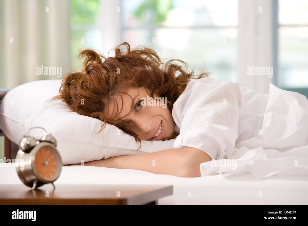 portrait of nice young woman waking up in her bedroom Stock Photo - Alamy