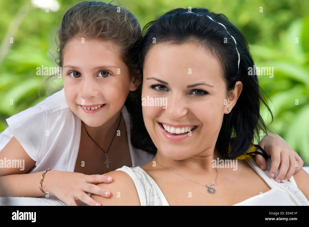 portrait of happy mother with daughter having good time in summer ...