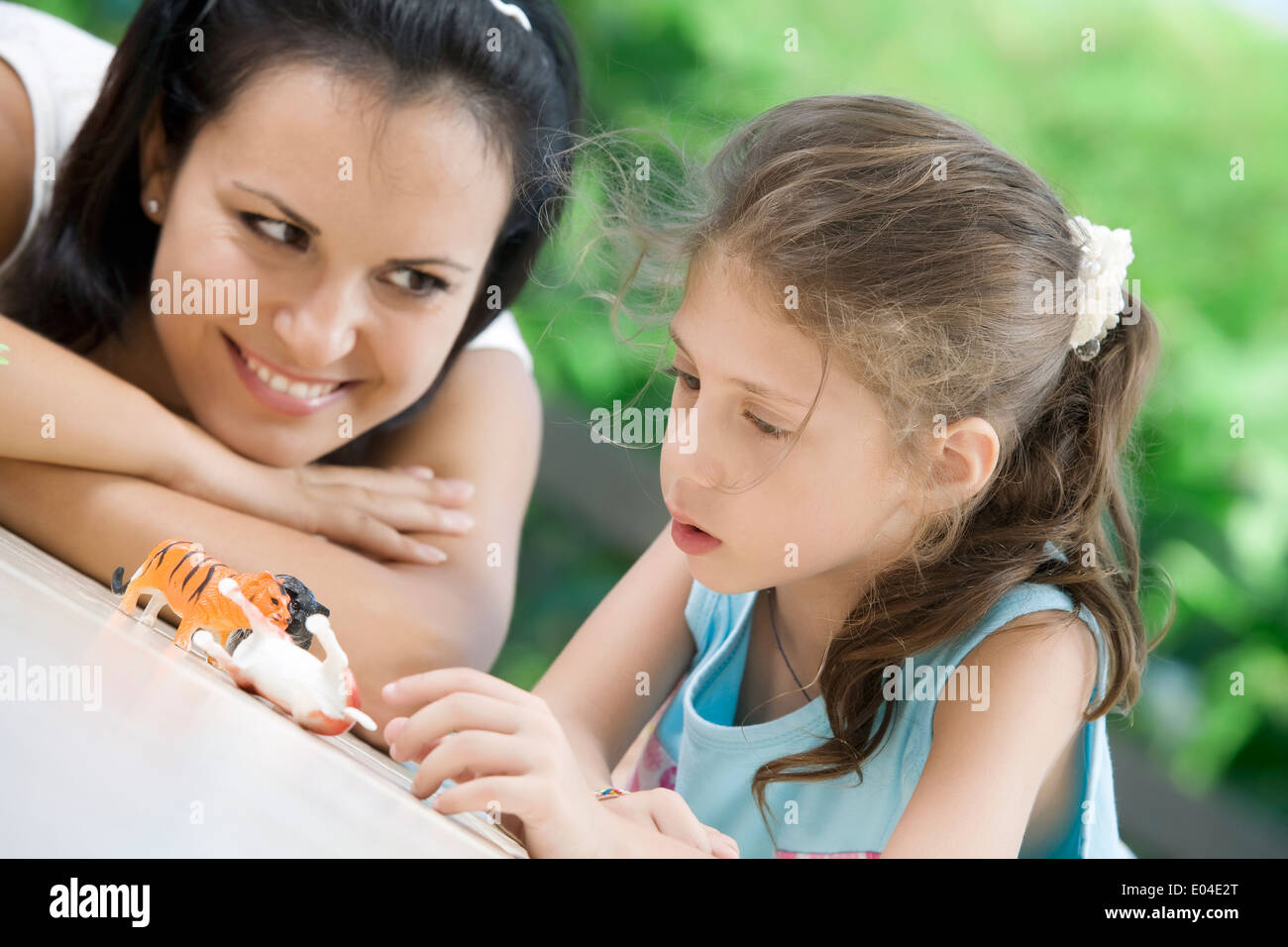 portrait of happy mother with daughter having good time in summer ...