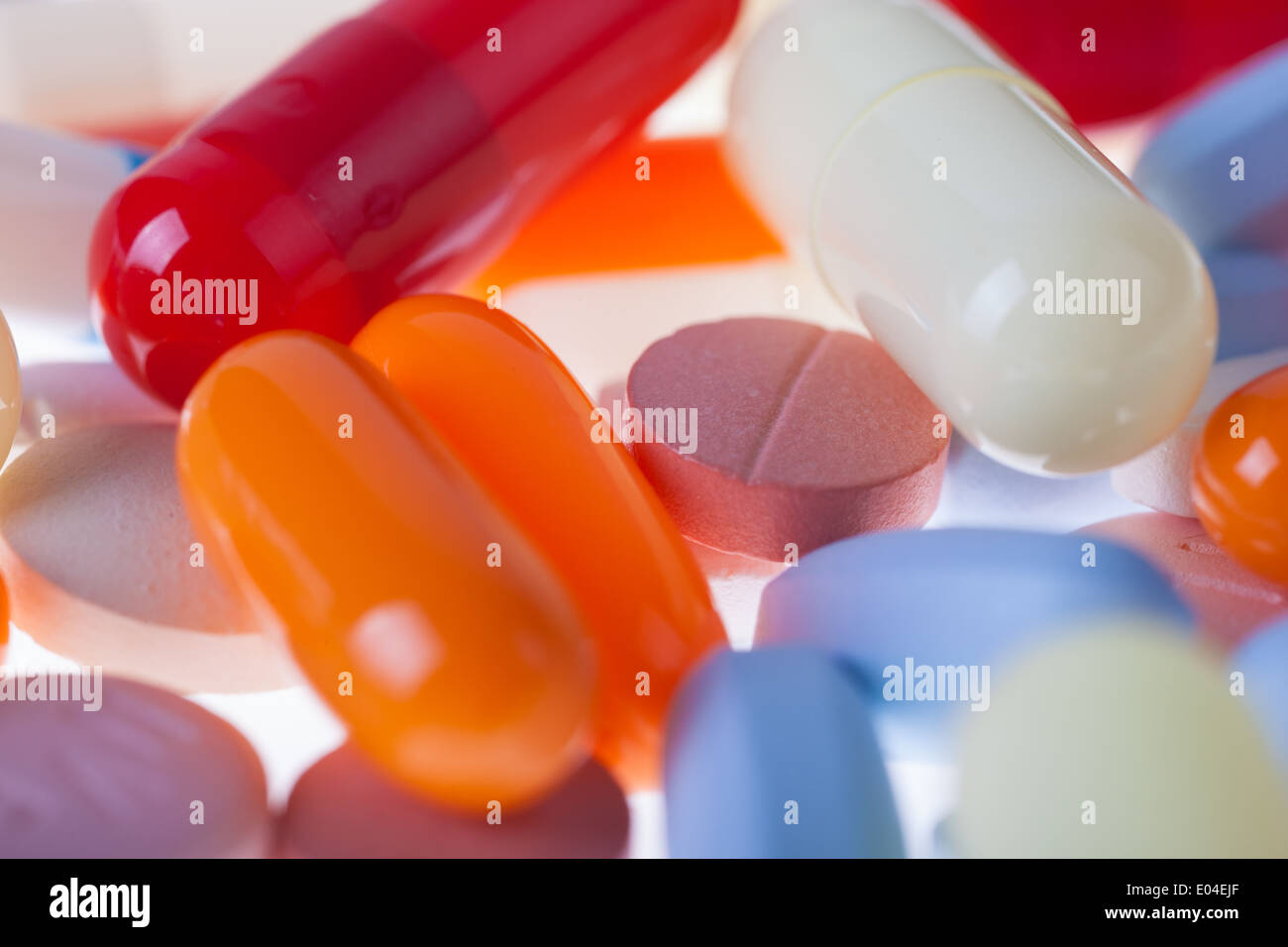 A lot of colored pills and tablets over a white background Stock Photo ...
