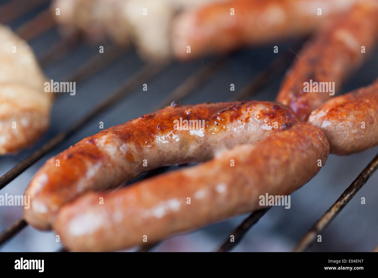 Several type of meats being cooked on a barbecue Stock Photo - Alamy