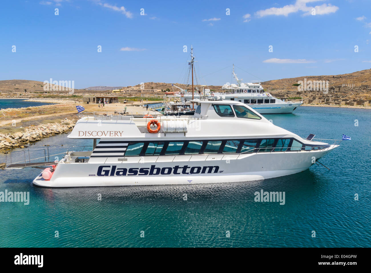 Glass bottom tourist boat anchored at the island of Delos, Cyclades ...