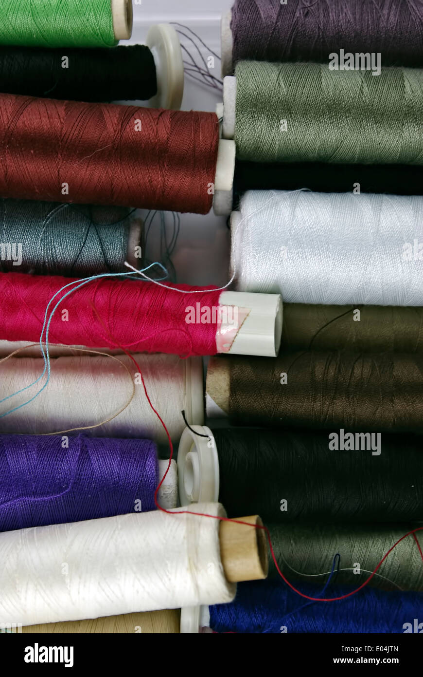 Sewing cotton in different colors, packed and unpacked, in plastic box ...