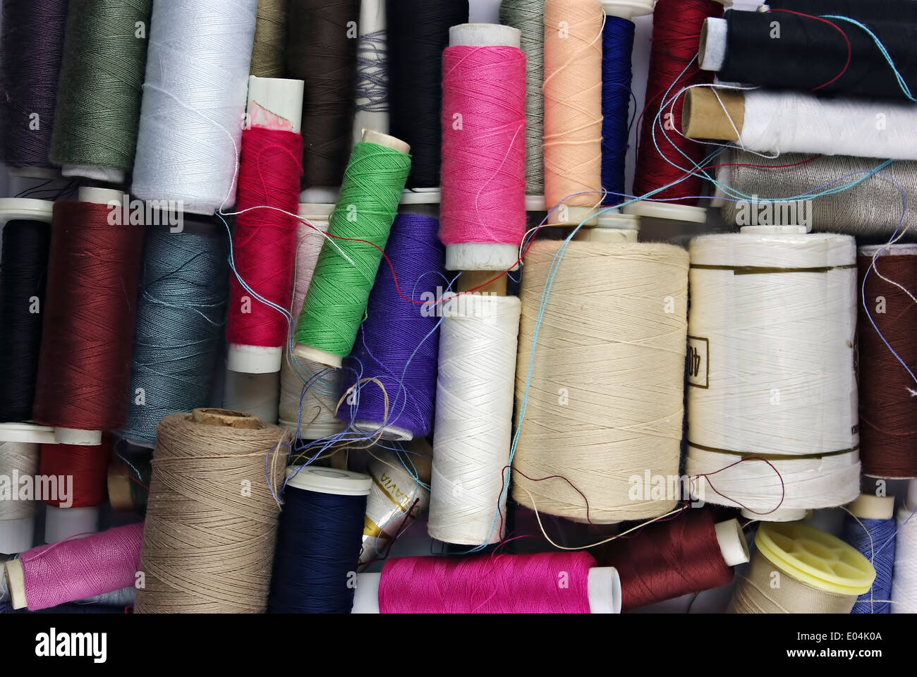 Sewing cotton in different colors, packed and unpacked, in plastic box ...