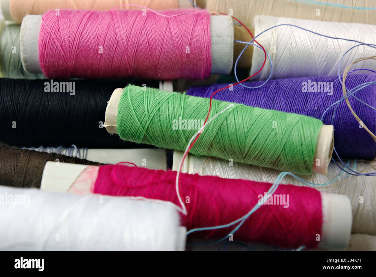 Sewing cotton in different colors, packed and unpacked, in plastic box ...
