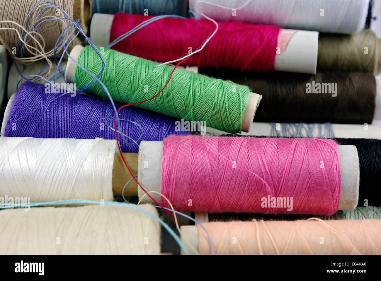 Sewing cotton in different colors, packed and unpacked, in plastic box ...