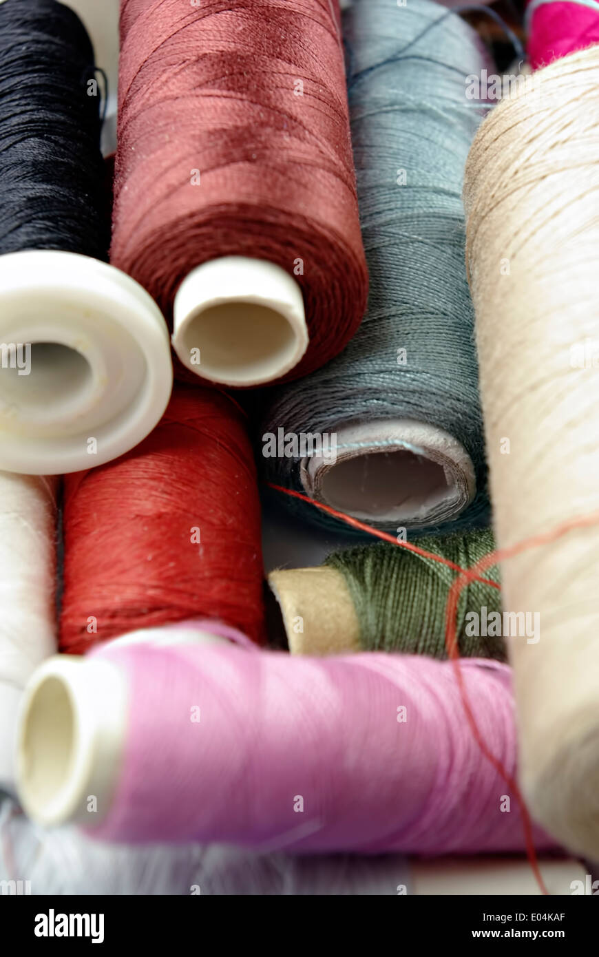 Sewing cotton in different colors, packed and unpacked, in plastic box ...