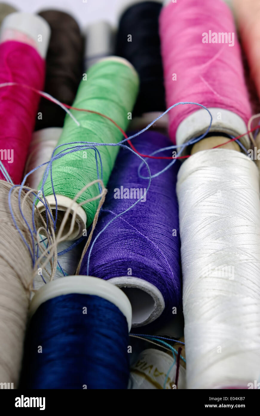 Sewing cotton in different colors, packed and unpacked, in plastic box ...